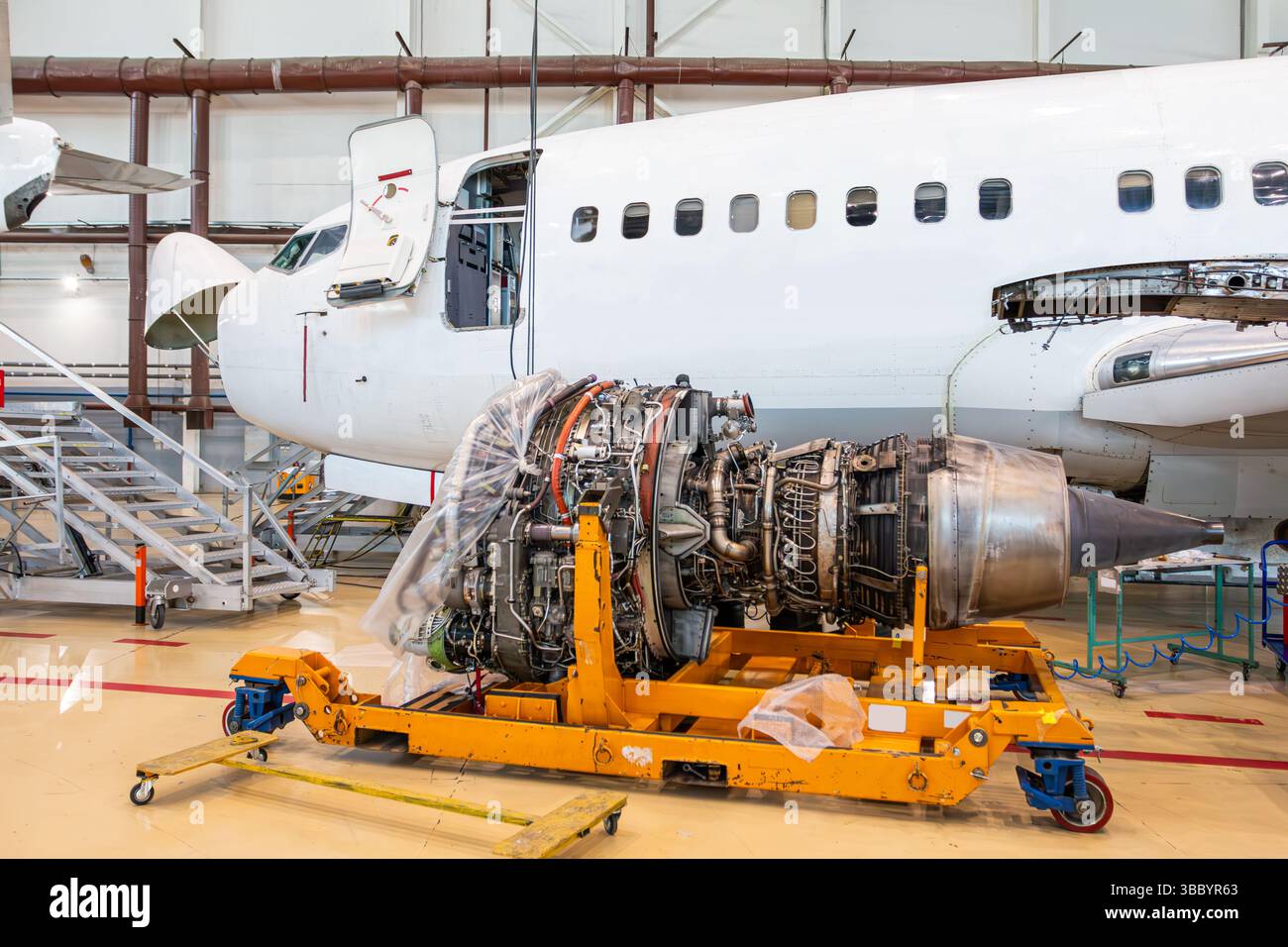 Passenger airplane near to high-bypass turbofan aircraft engine in ...