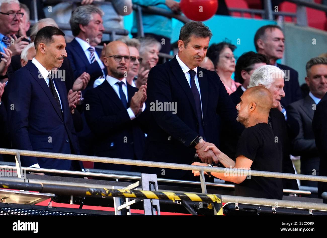 Manchester City CEO Ferran Soriano greets manager Pep Guardiola ...