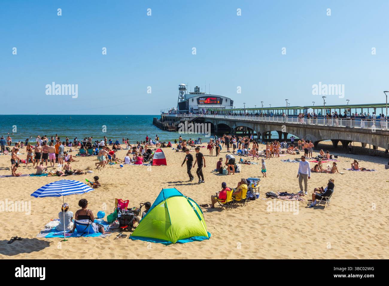 East Cliff Beach, Bournemouth, UK - May 17th 2025: People sunbathing on ...