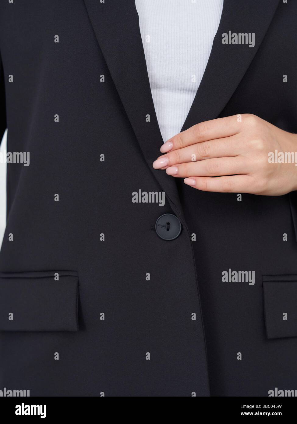 Blonde model showcases stylish black blazer in a studio setting Stock ...