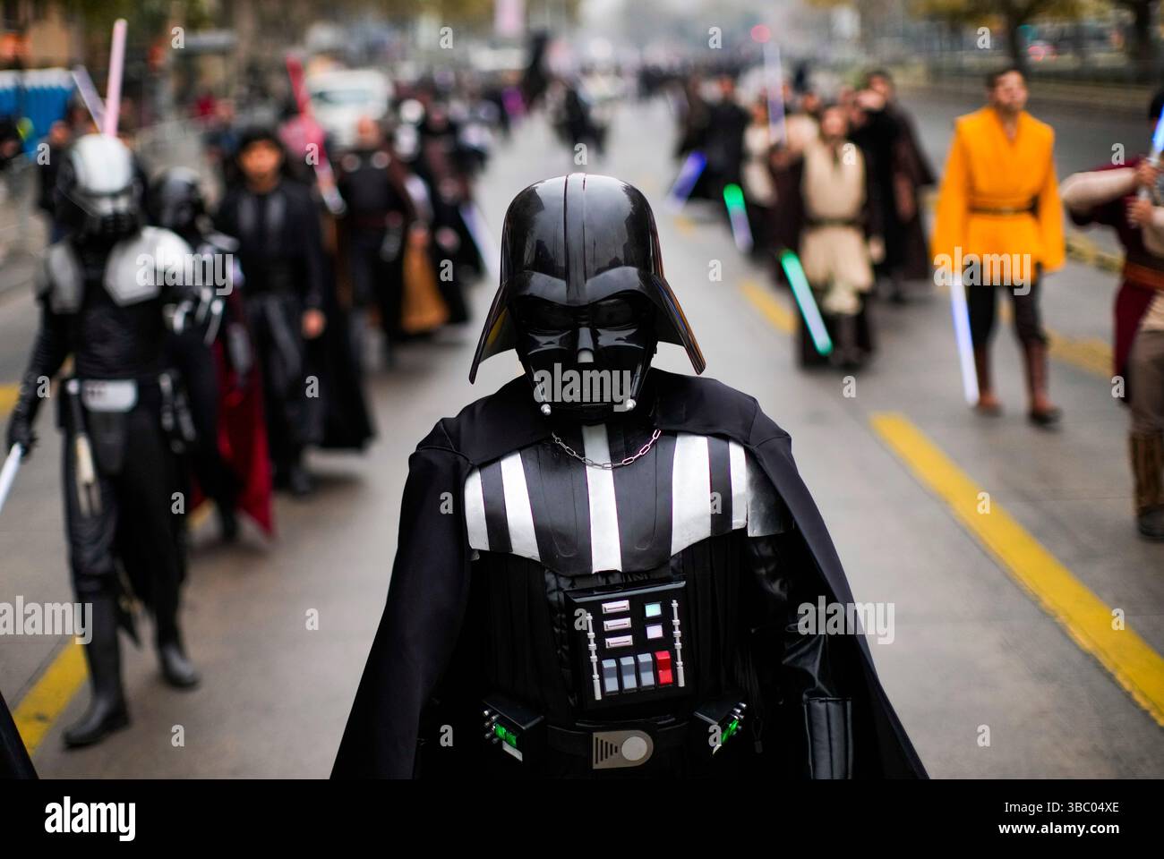 Fans dressed in costumes take part in a parade celebrating the month of ...