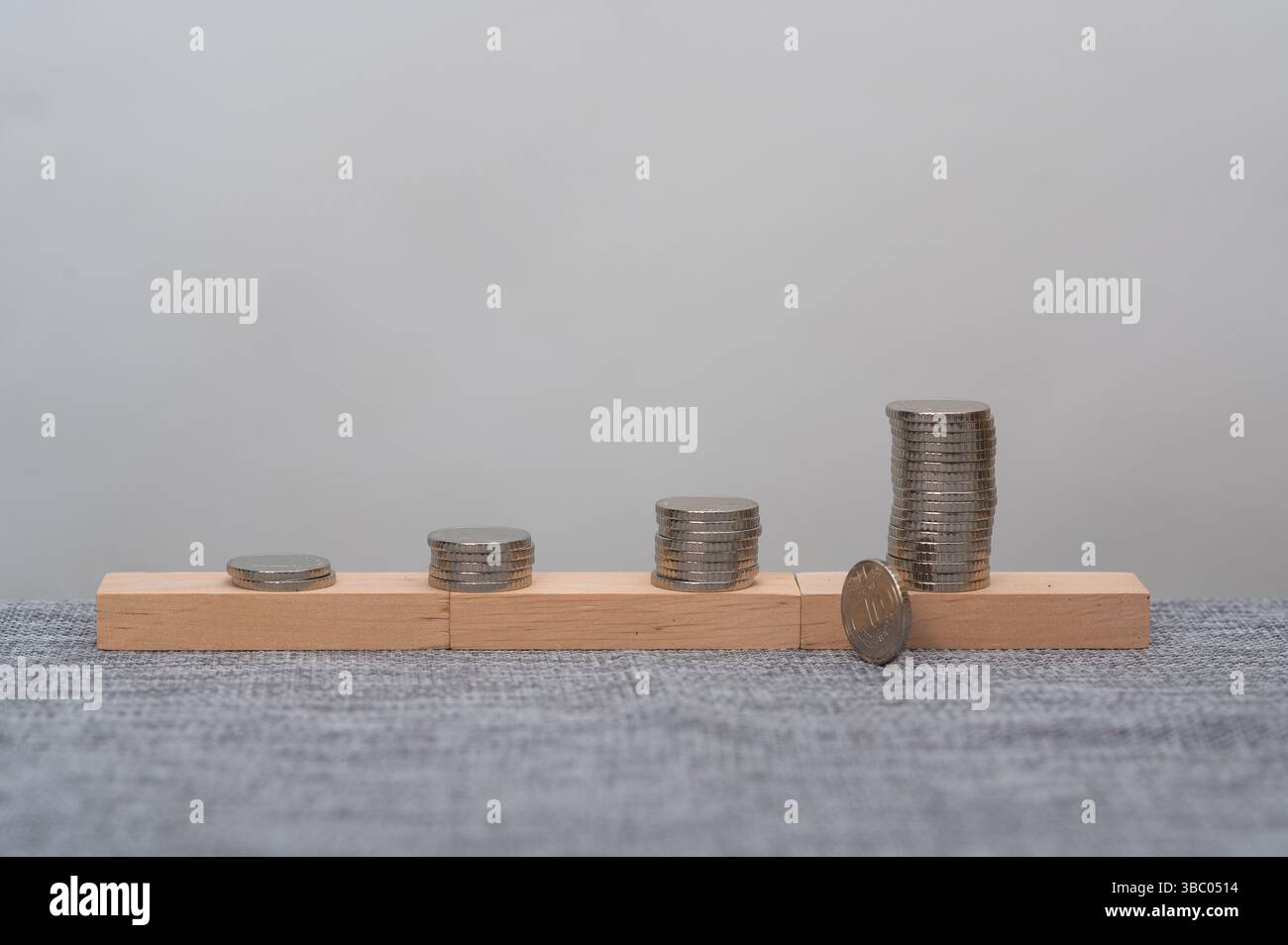 money and coins in piles, the amount grows. the concept of saving and ...