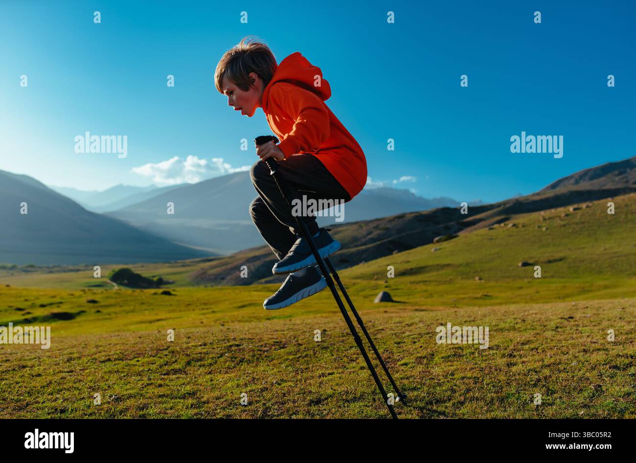 Happy boy hiker jumps hi-res stock photography and images - Alamy