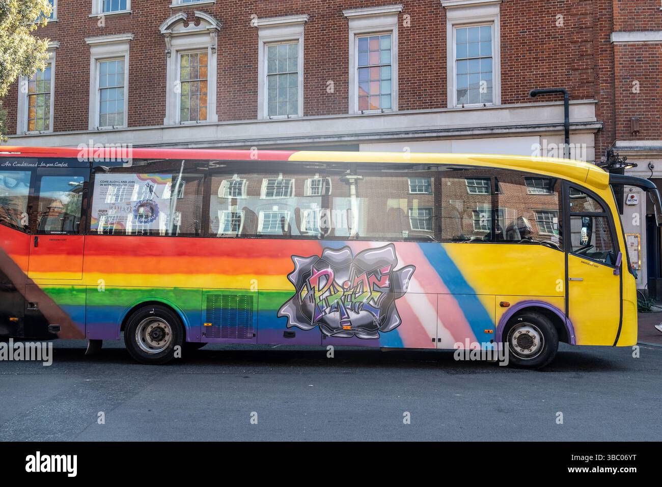 Yellow and Rainbow Pride Bus, Reading Stock Photo - Alamy