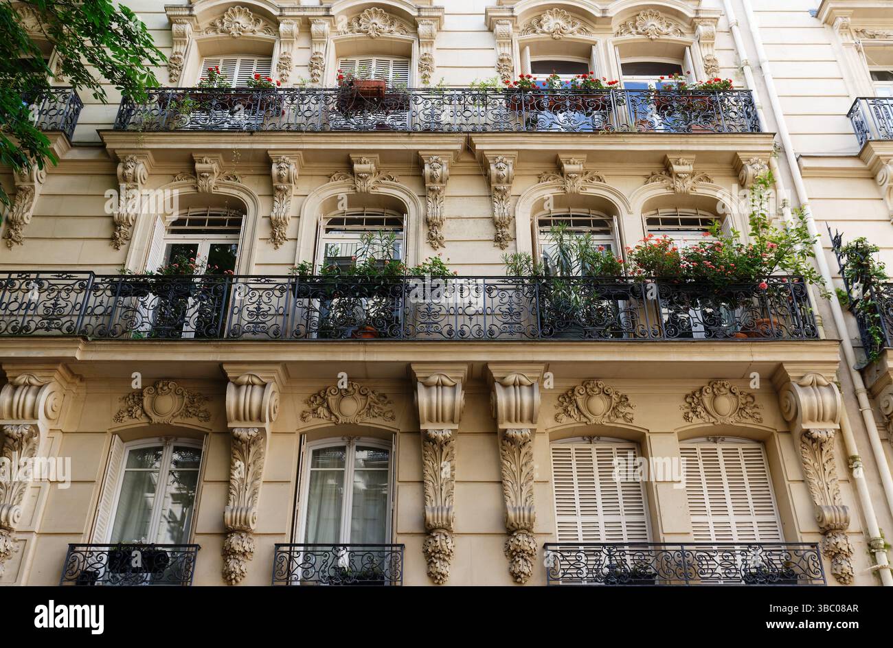 The facade of traditional French house with typical balconies and ...