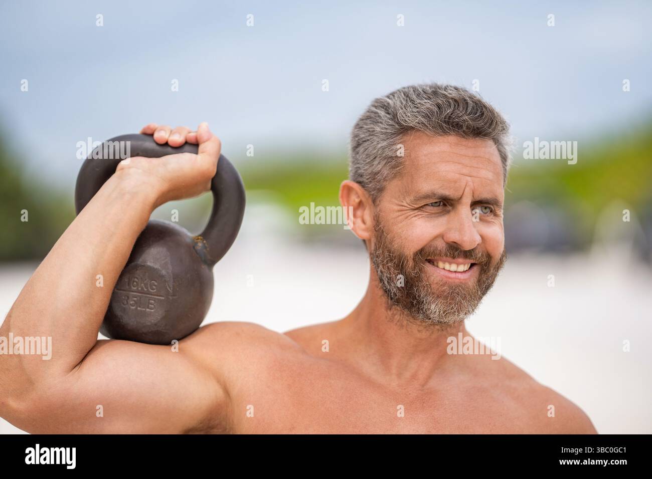 Strong happy man do sport exercise. Gym workout. Sport athlete man hold ...