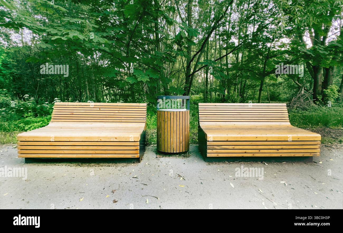 two wooden and bin in forest park Stock Photo - Alamy