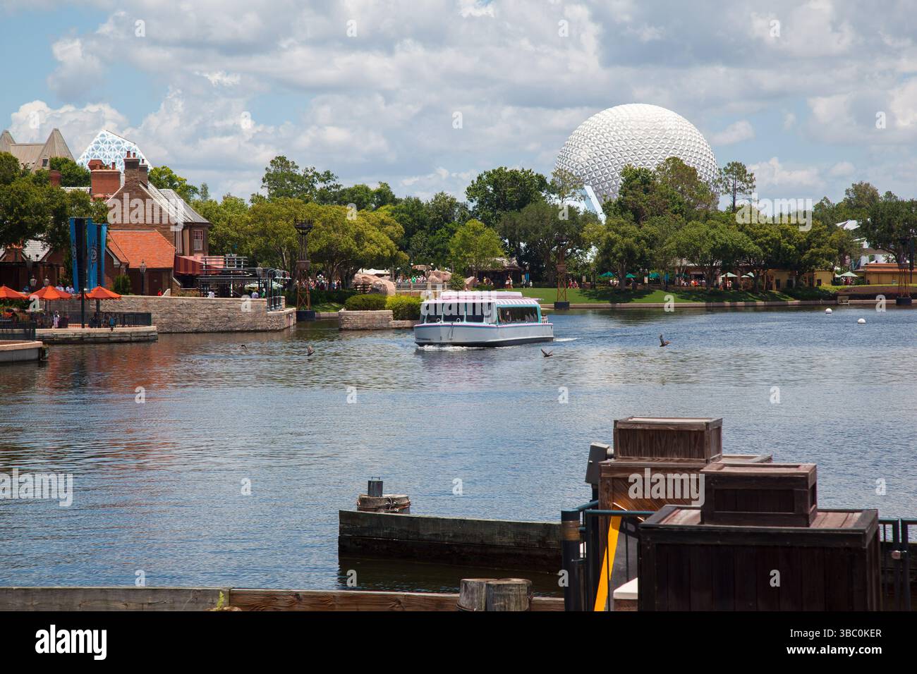 A Boat on World Showcase lake, and Spaceshipe earth dome at Epcot ...