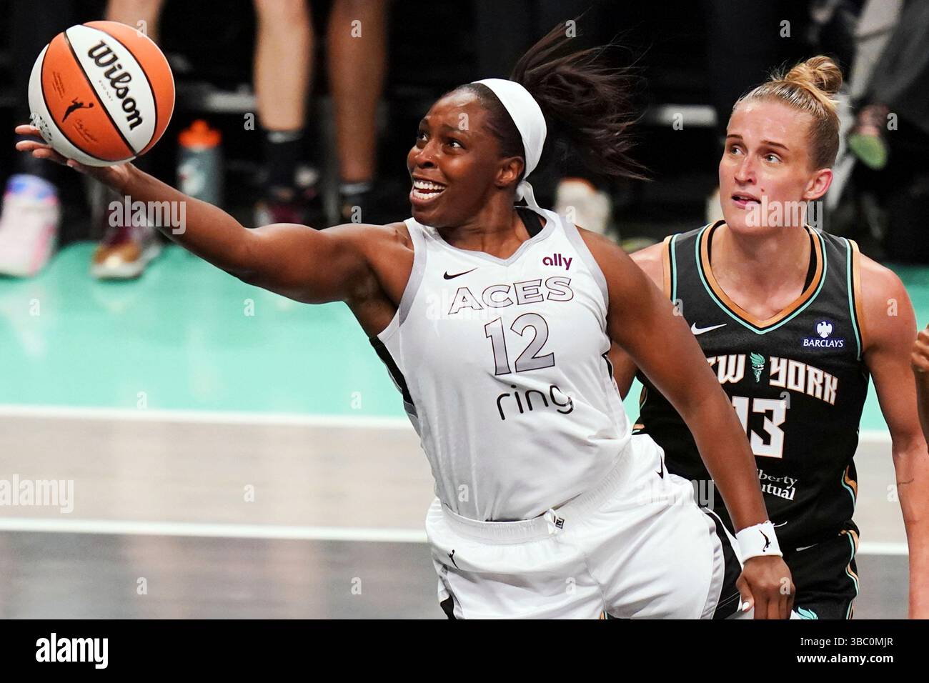Las Vegas Aces guard Chelsea Gray (12) reaches for the ball around New ...