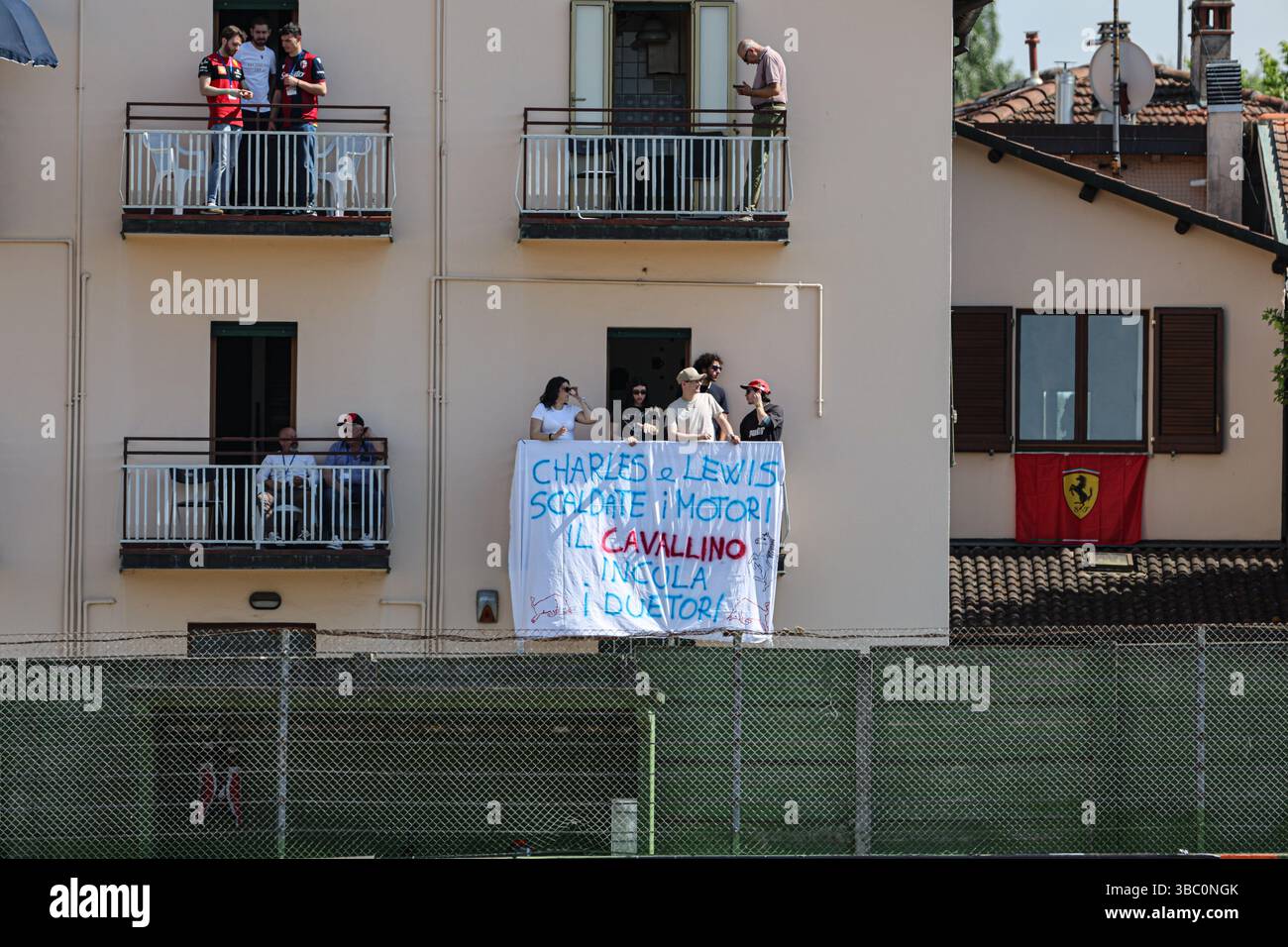 People and supporters watching the show from home, near the track ...