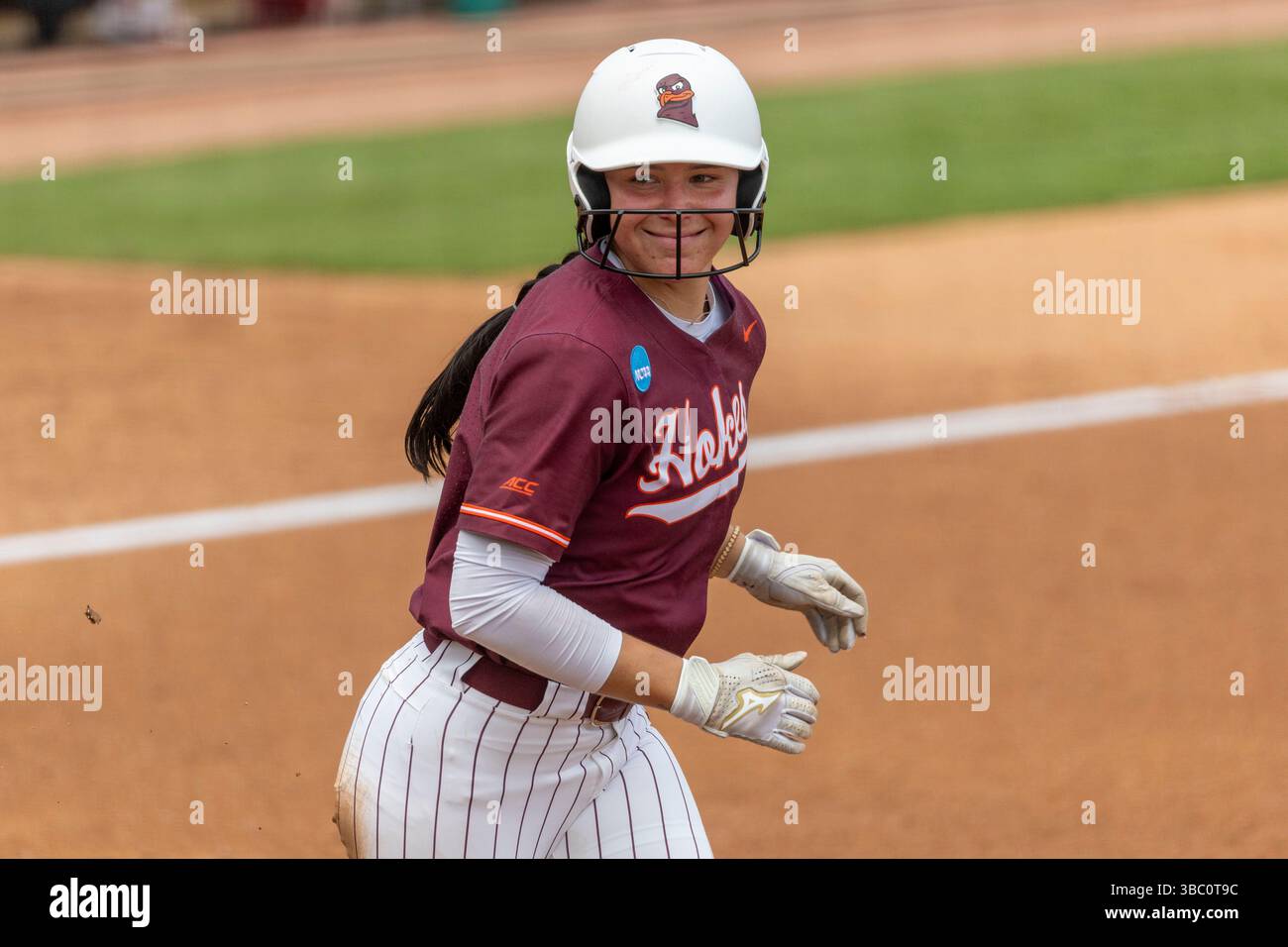 Virginia Tech outfielder Cori McMillan (2) smiles as she jogs to first ...