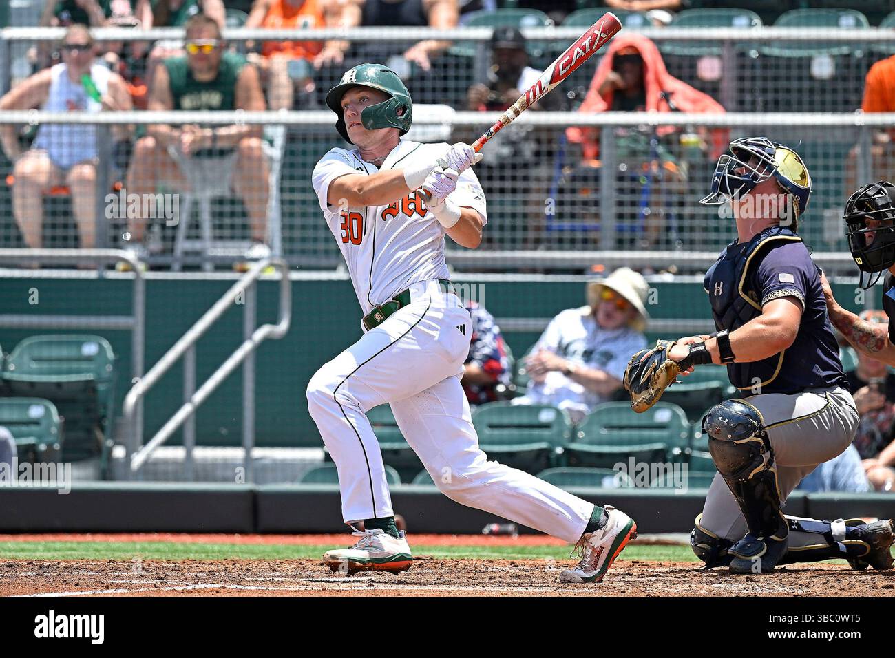 CORAL GABLES, FL - MAY 17: Miami catcher Tanner Smith (30) hits a ...