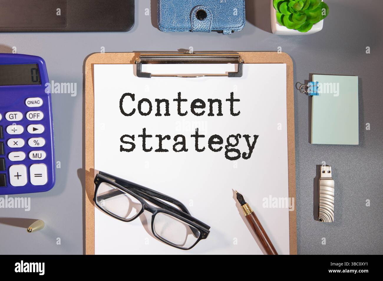 Content Strategy text on paper sheet with chart, color pan and alarm ...