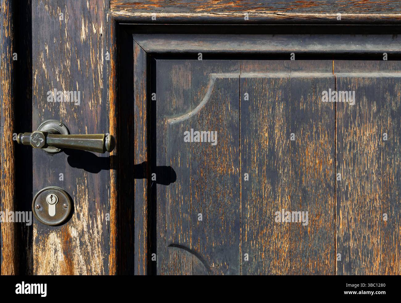 Close-up of a weathered chapel door with vintage handle and keyhole ...
