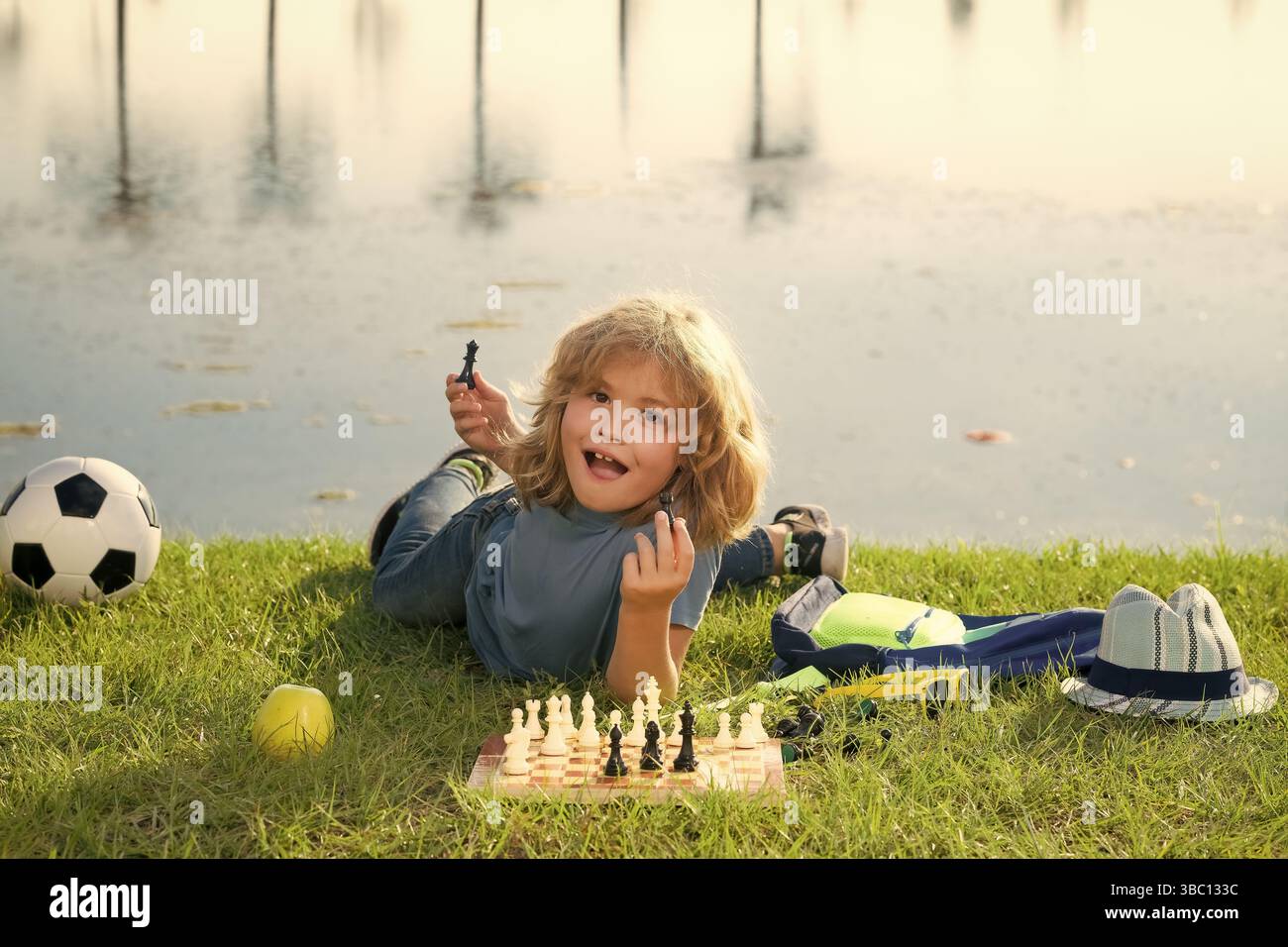 Kid shows chess pieces on a chessboard. Little child play chess. Kid ...