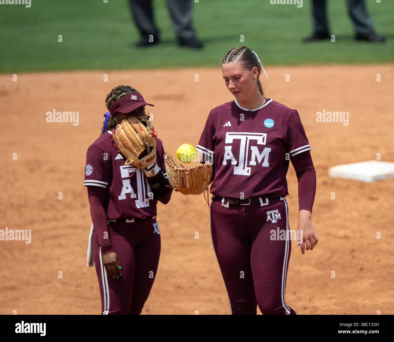 Texas A&M infielder Koko Wooley, left, and pitcher Emiley Kennedy ...