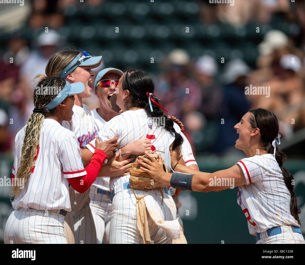 The Liberty softball team celebrates after a win over Texas A&M in an ...