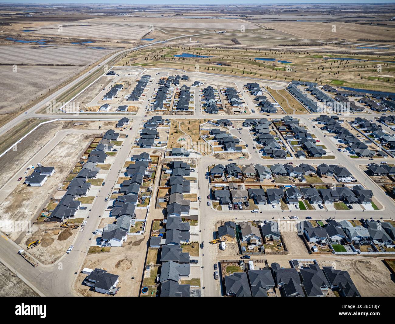 Residential area with many houses and a few cars. The houses are mostly ...