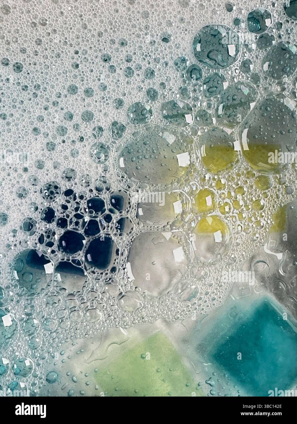 Bubbles & colorful water with glass shows foam white crest in water ...