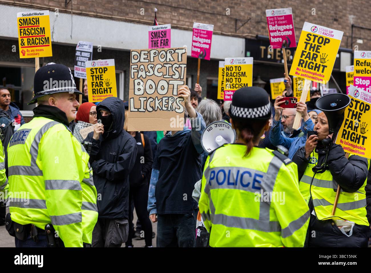 Birmingham, UK. 17 MAY, 2025. Counter protestors hold various signs as ...