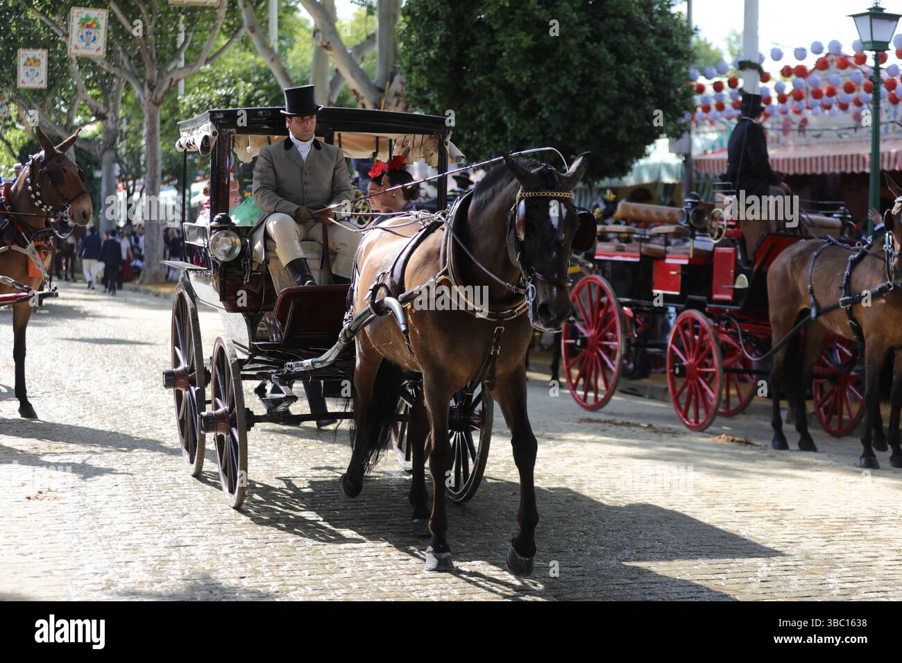 Seville, May 6, 2025. April Fair. Carriages with drivers dressed in ...