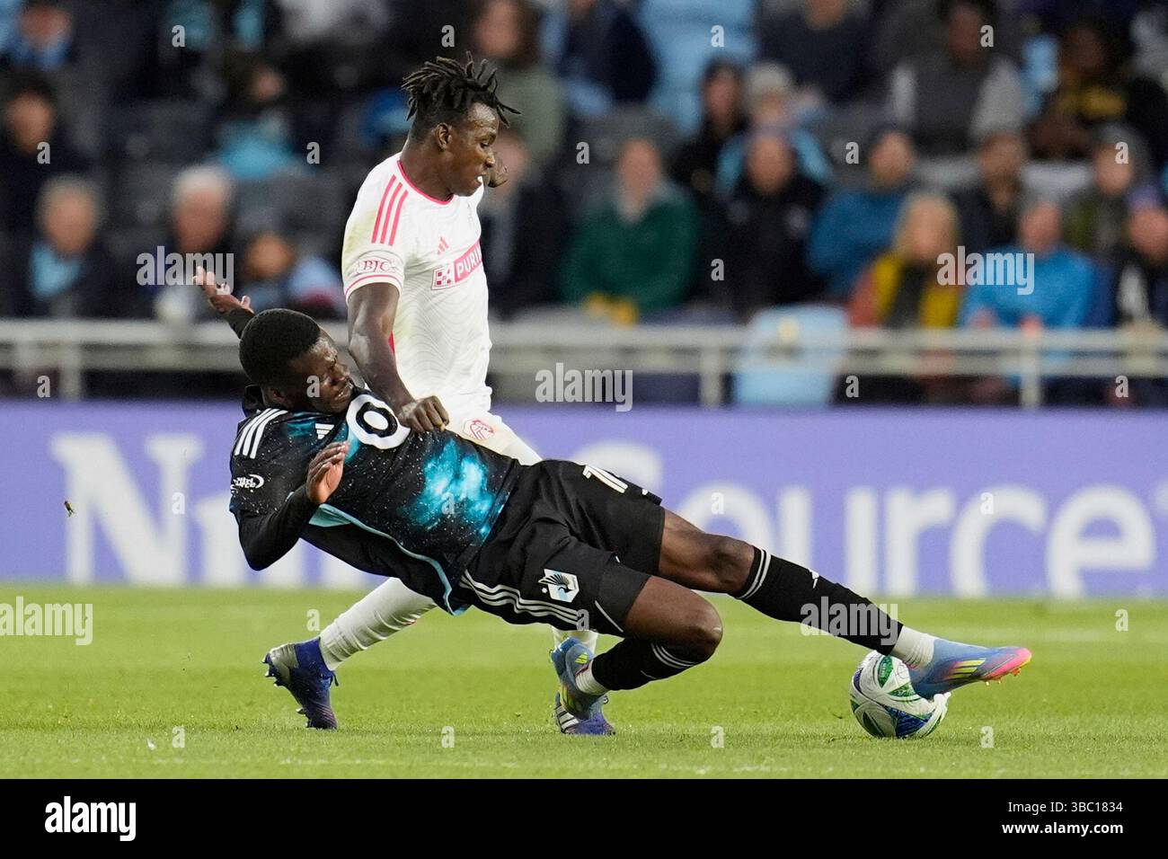 Minnesota United forward Tani Oluwaseyi, bottom, reaches for the ball ...
