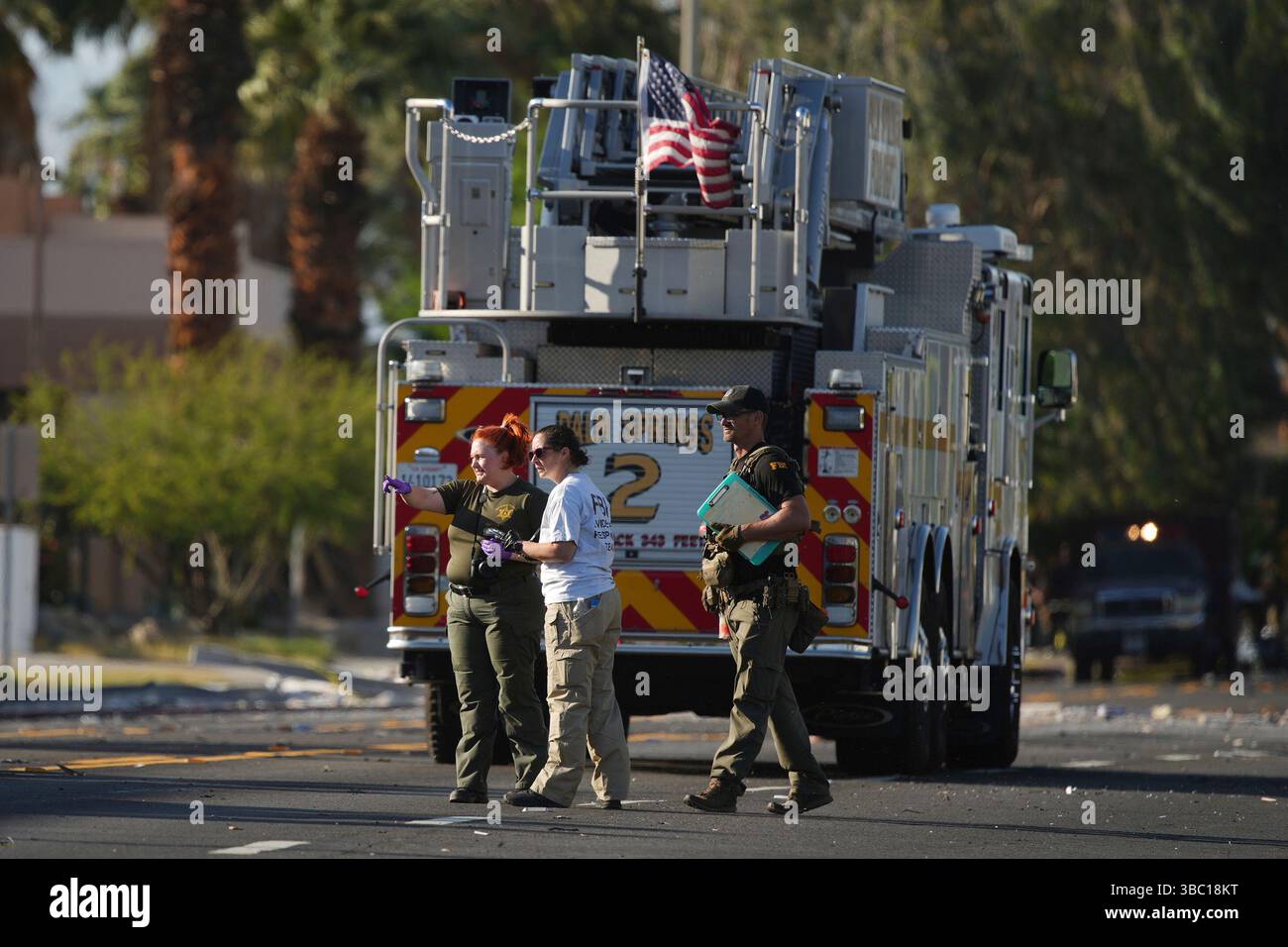 Investigators walk the on the scene of an explosion Saturday, May 17 ...