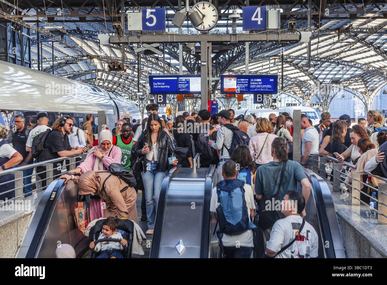 Cologne Central Station. Stairs to the platforms. Travellers waiting ...