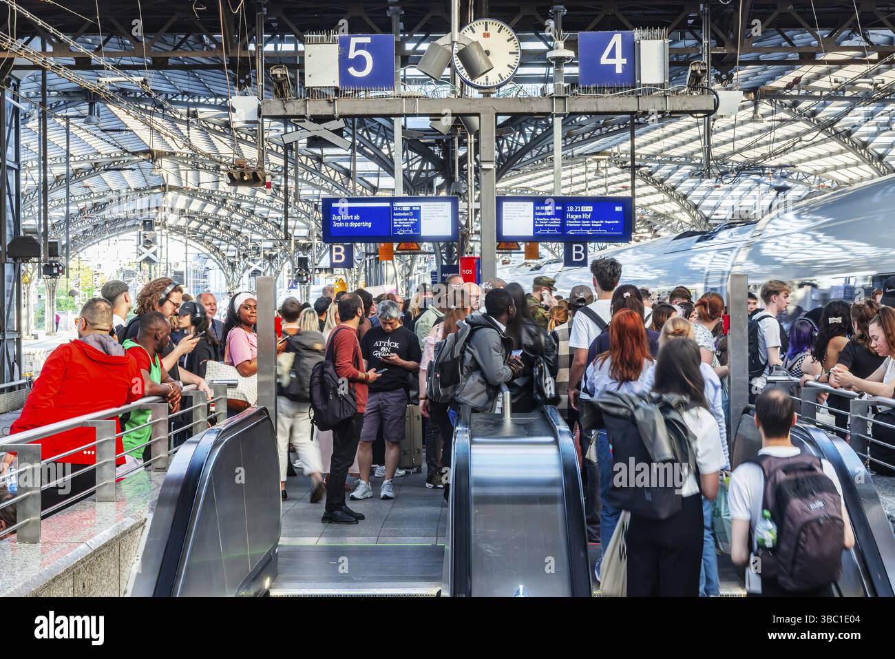 Cologne Central Station. Stairs to the platforms. Travellers waiting ...