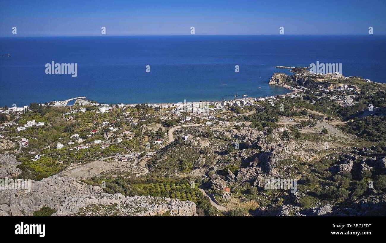 Aerial view of a wide coastal landscape with lush vegetation and blue ...