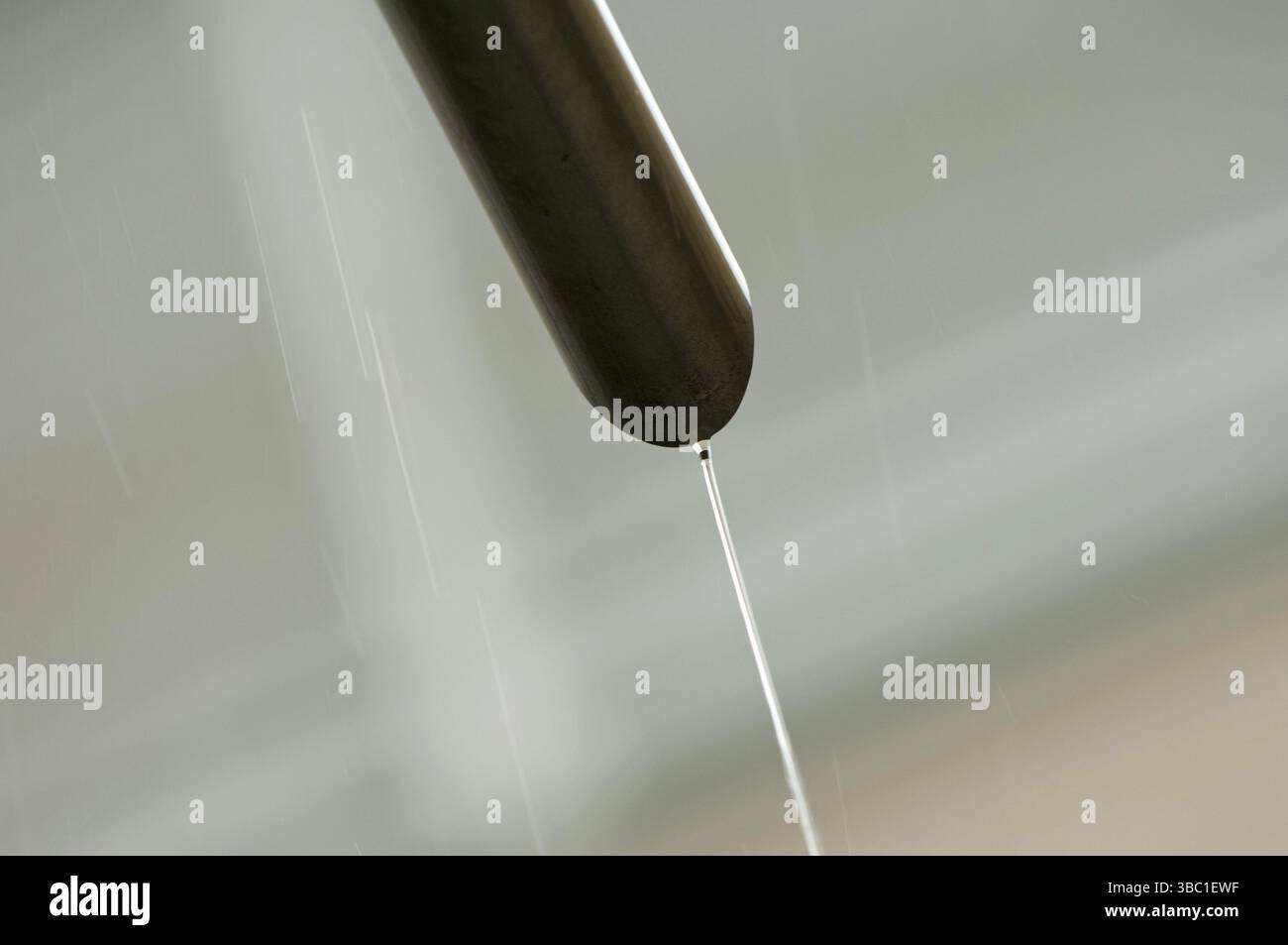 Water flows out of the gutter Stock Photo - Alamy