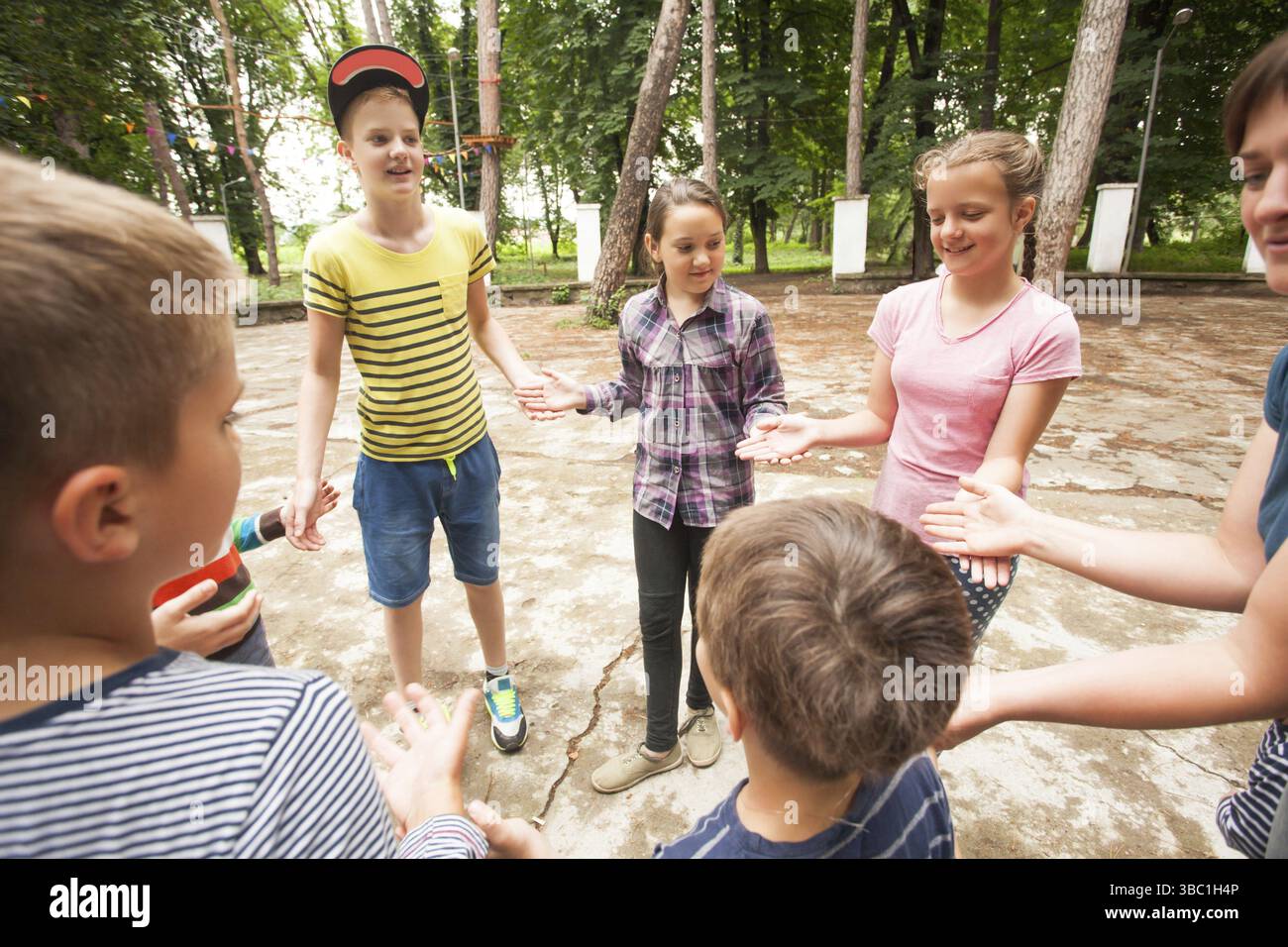Children playing the game outdoors clapping hands in a circle Stock ...