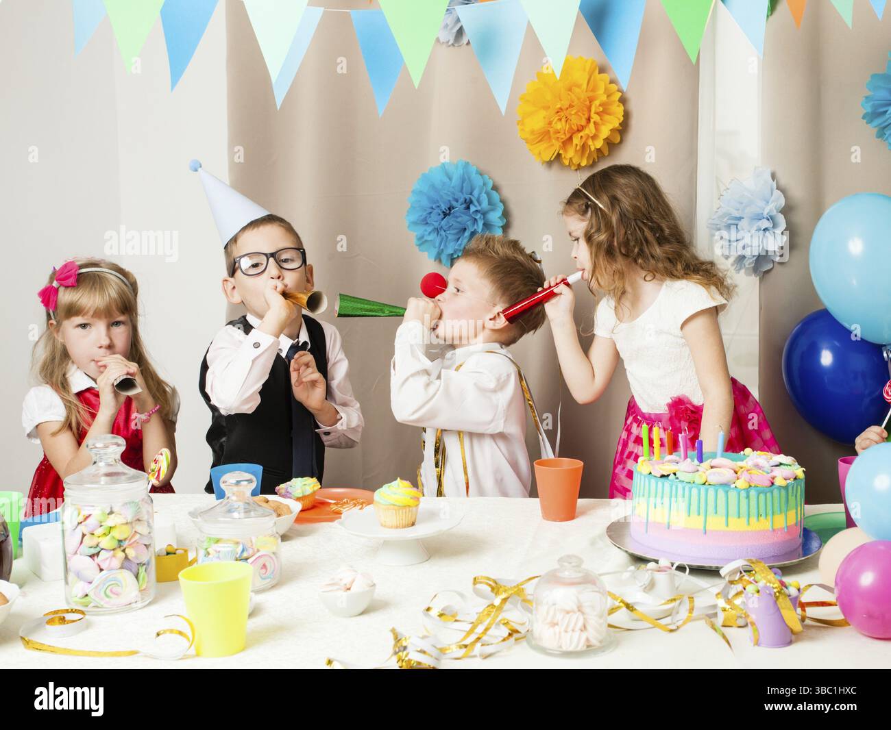 Group of smiling children playing on the birthday party in decorated ...