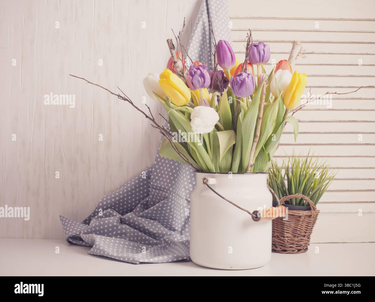 Color tulips with branches in a white cane. Spring decor Stock Photo ...