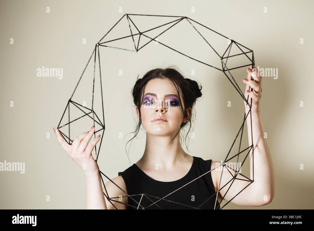 Fashion girl is posing with art geometry object, playful kitty face ...
