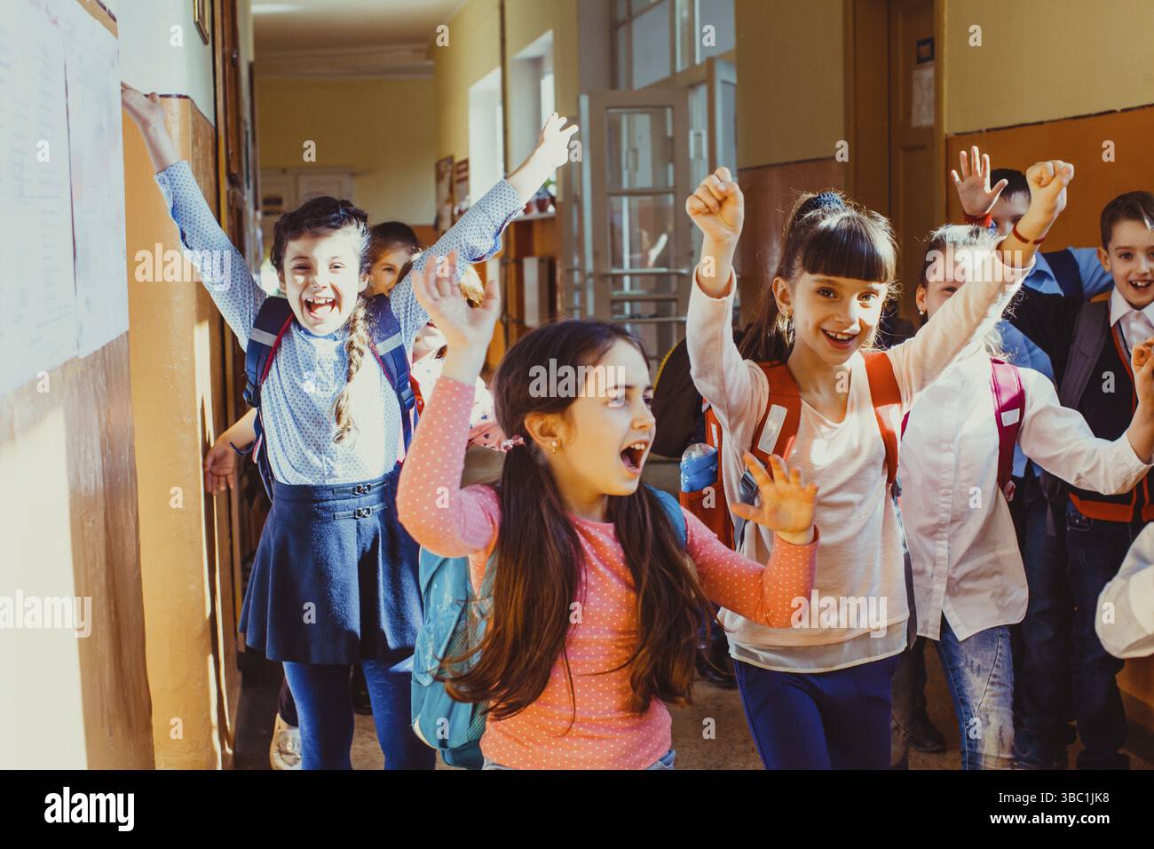 Happy pupils running out of the classroom on summer vacation Stock ...