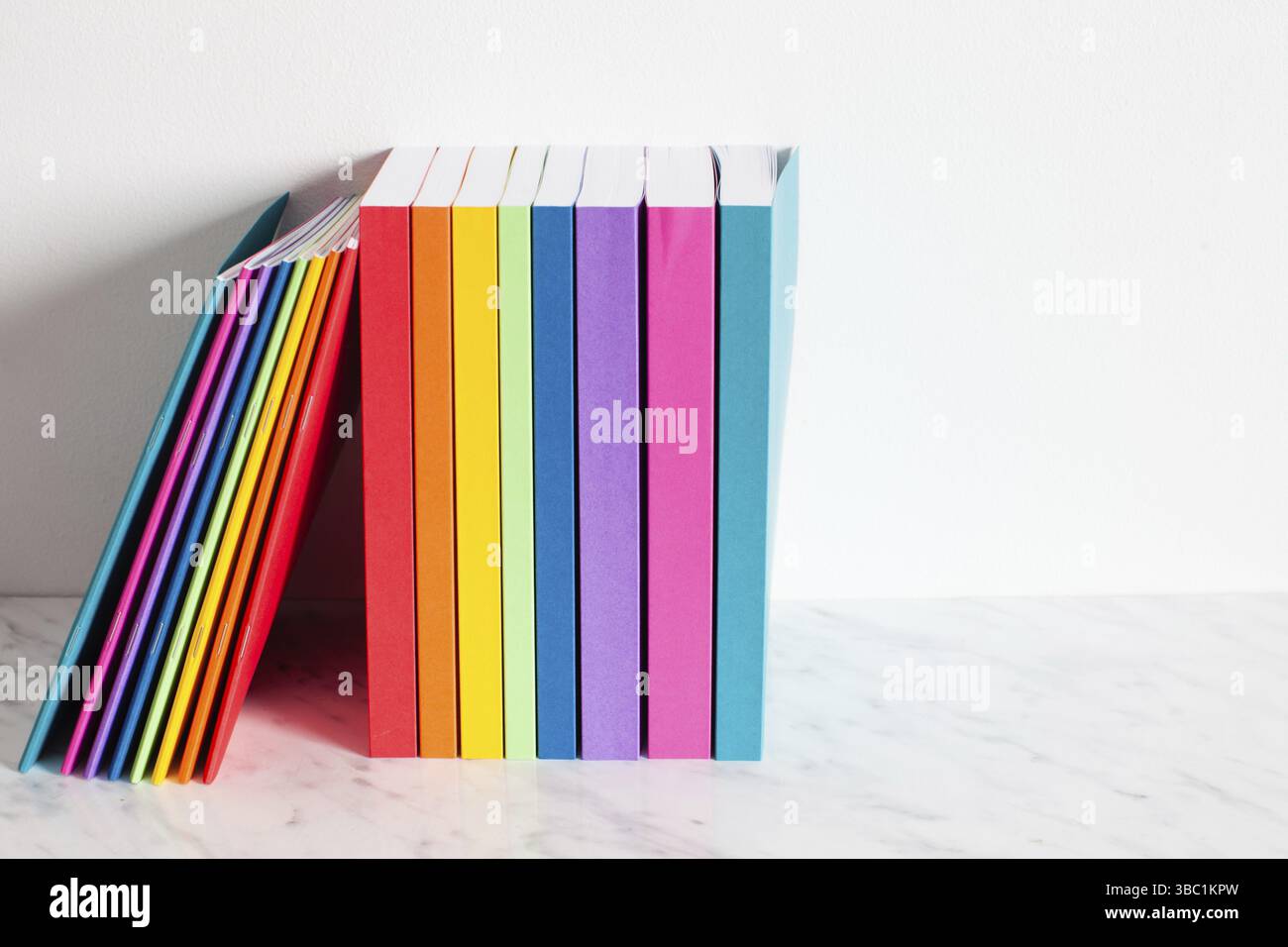 Colorful books are outlined in the colors of the rainbow. Stacked of ...