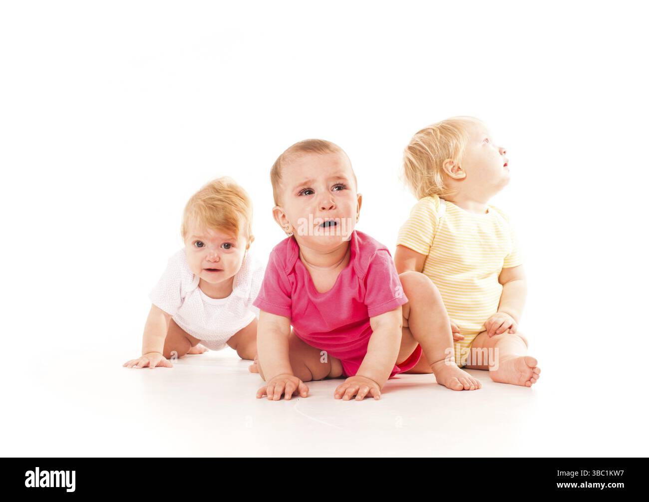 Three crying blondes babies, sitting isolated on white Stock Photo - Alamy