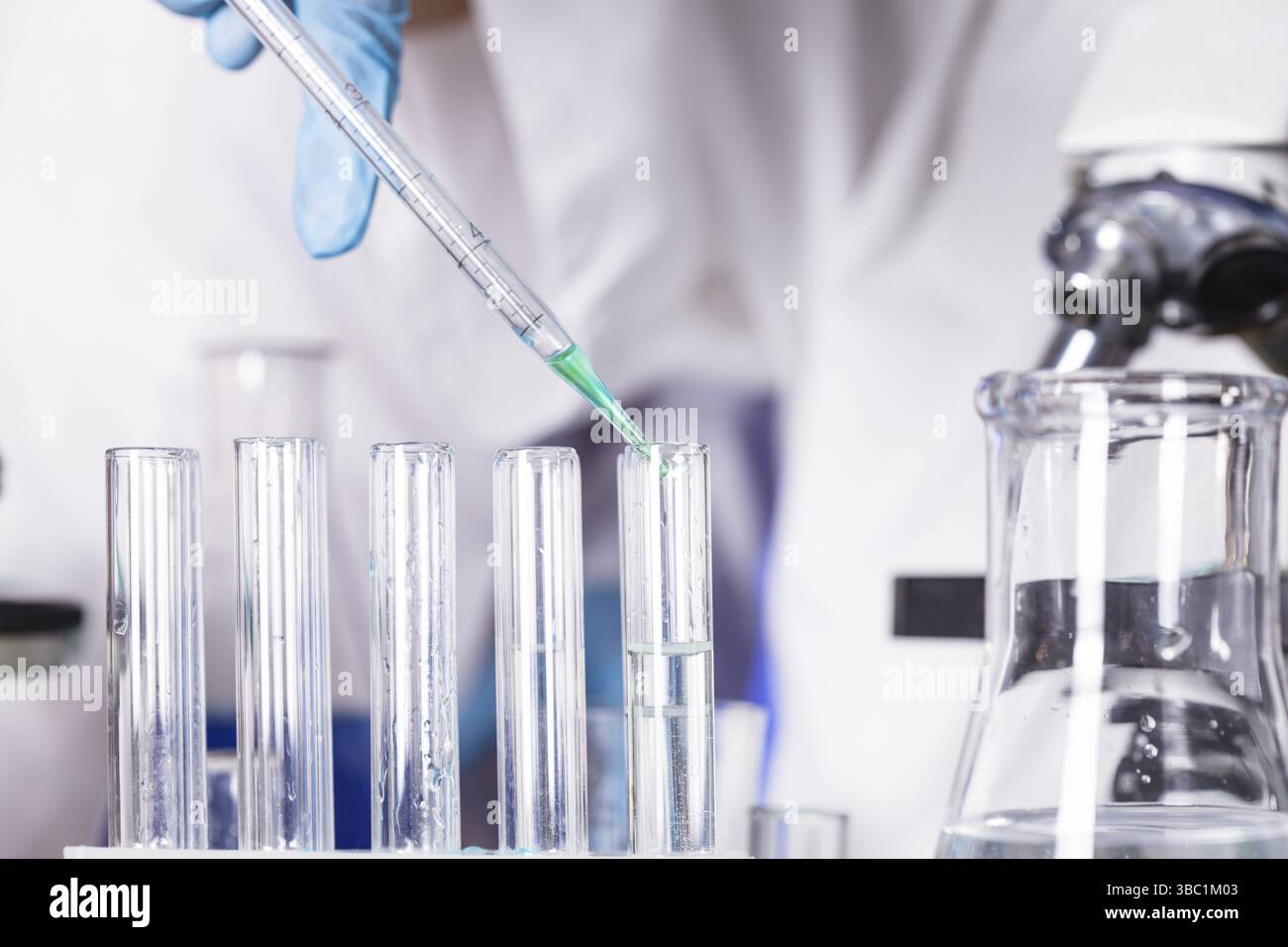 The blue drop from pipette in laboratory tubes Stock Photo - Alamy