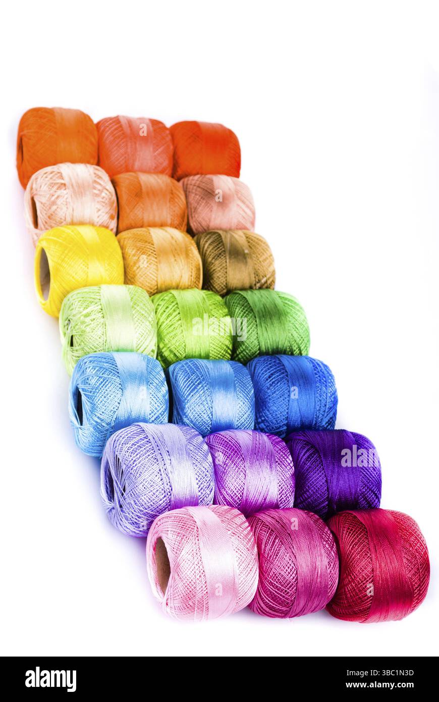 The collection of threads twisted in a ball is located on a white ...