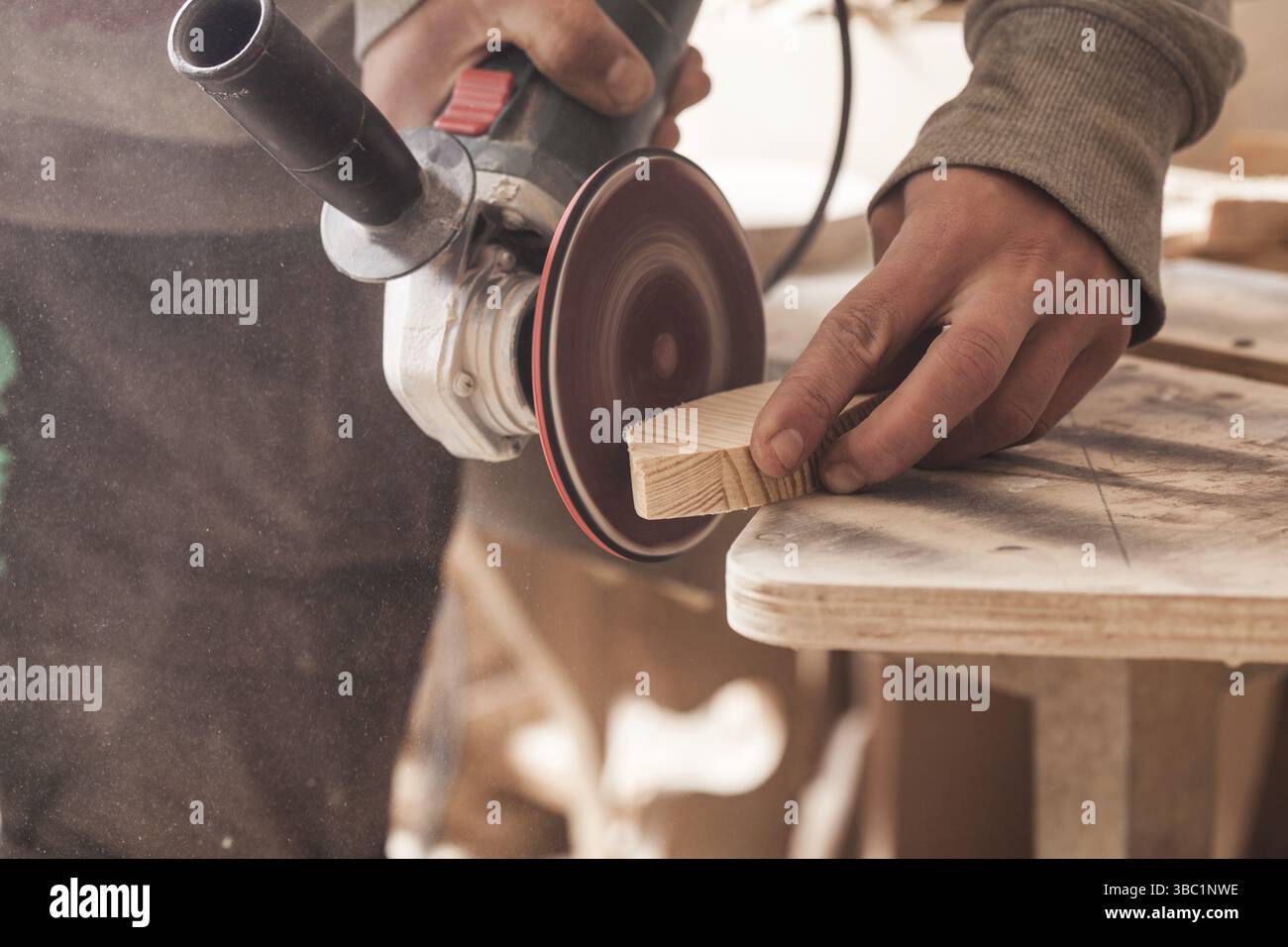 Worker polishing wood table where carpenter hands sanding a wood with ...
