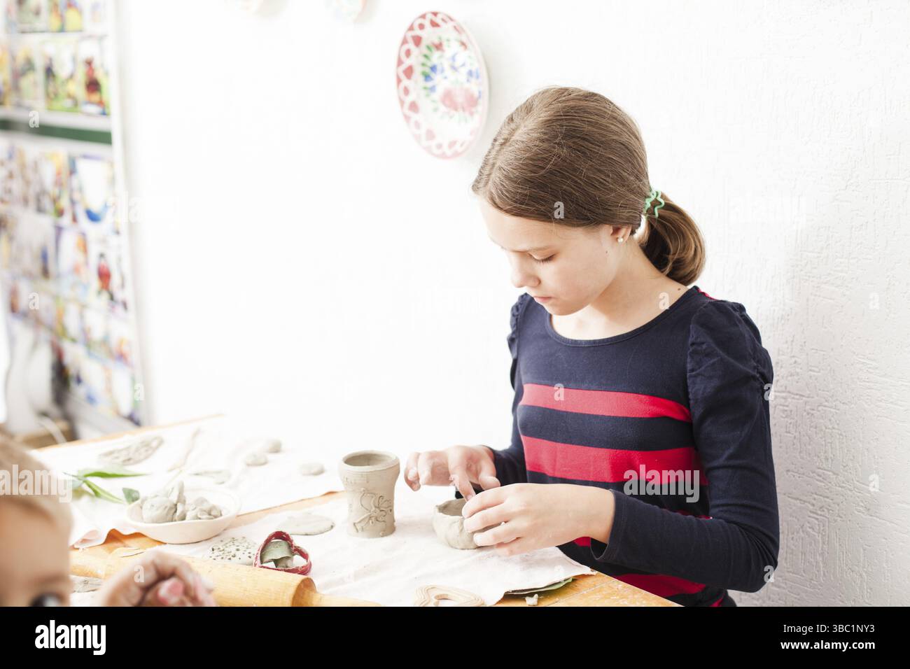 Process modeling figures from white clay, girls are making arts at the ...