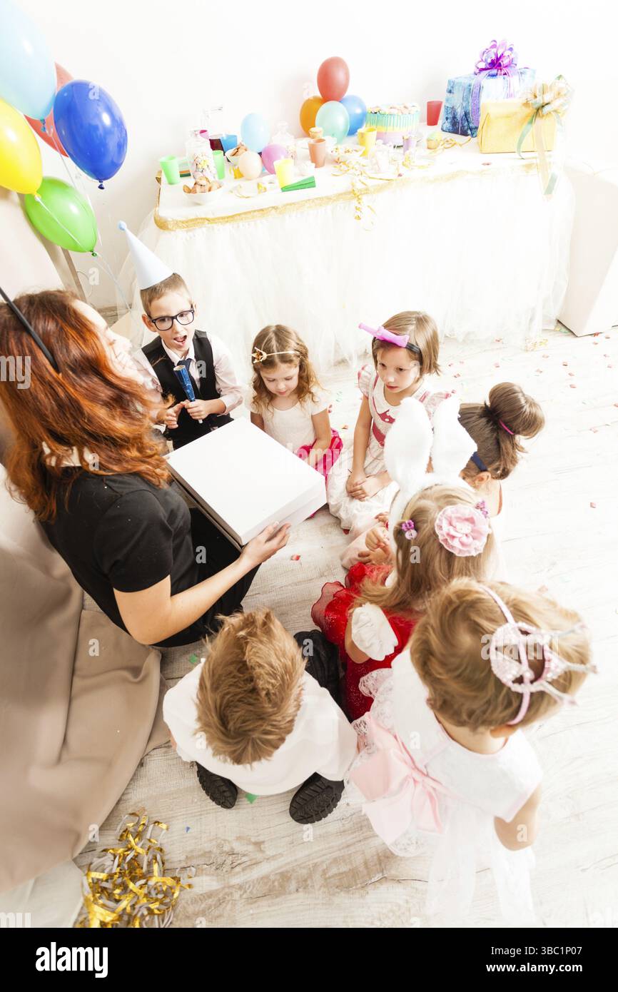 Cute kids playing with animator on the birthday party. Cat woman ...