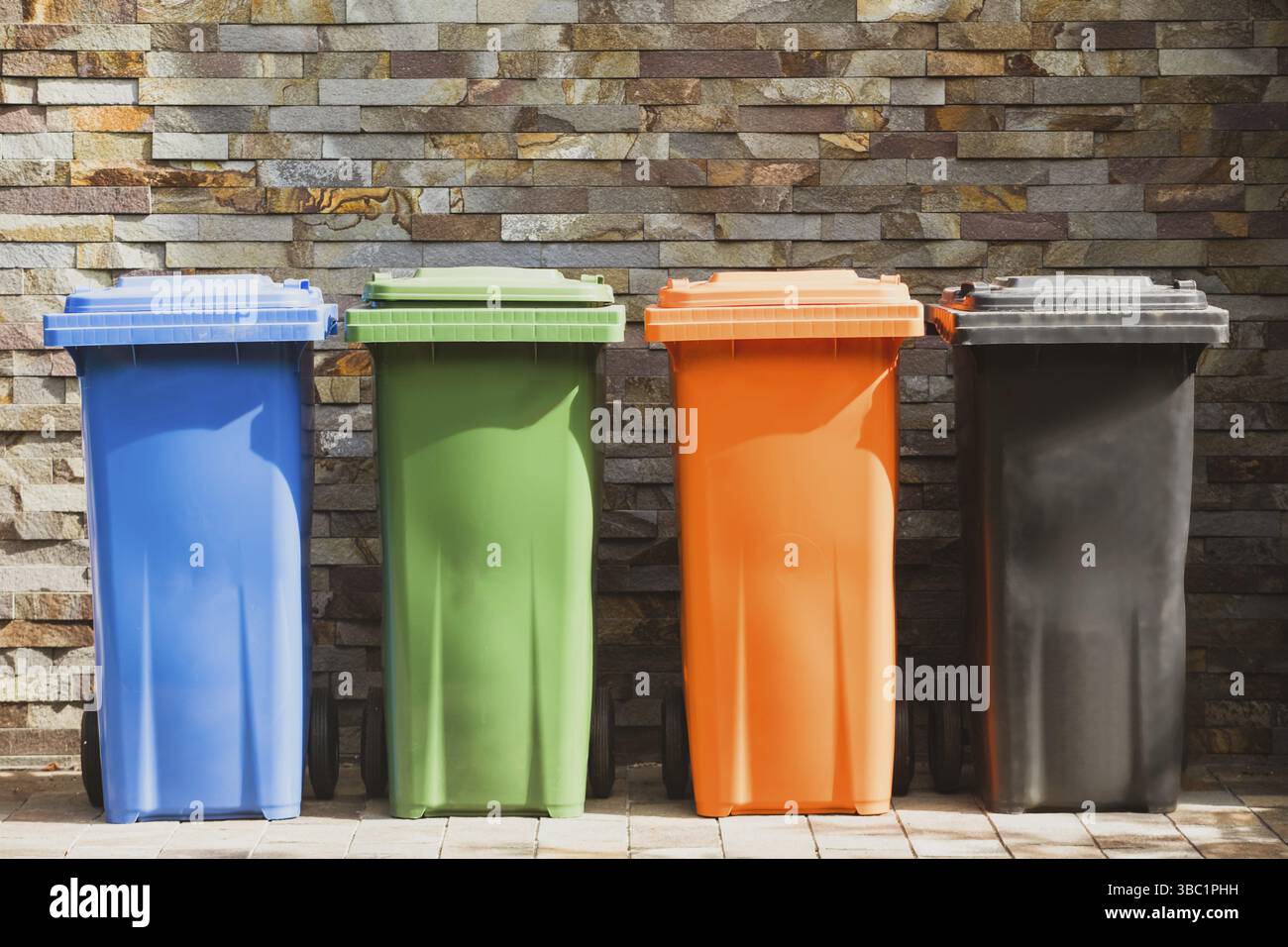 Four plastic trash containers of different colours for garbage ...