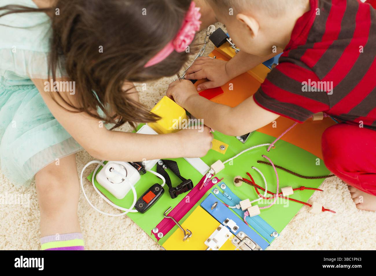 Handmade DIY busy board - sensory children's toy Stock Photo - Alamy