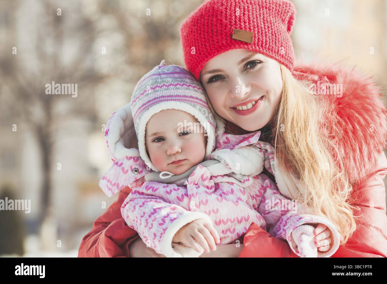 Mom hugging her daughter while walking in a winter sunny day Stock Photo - Alamy