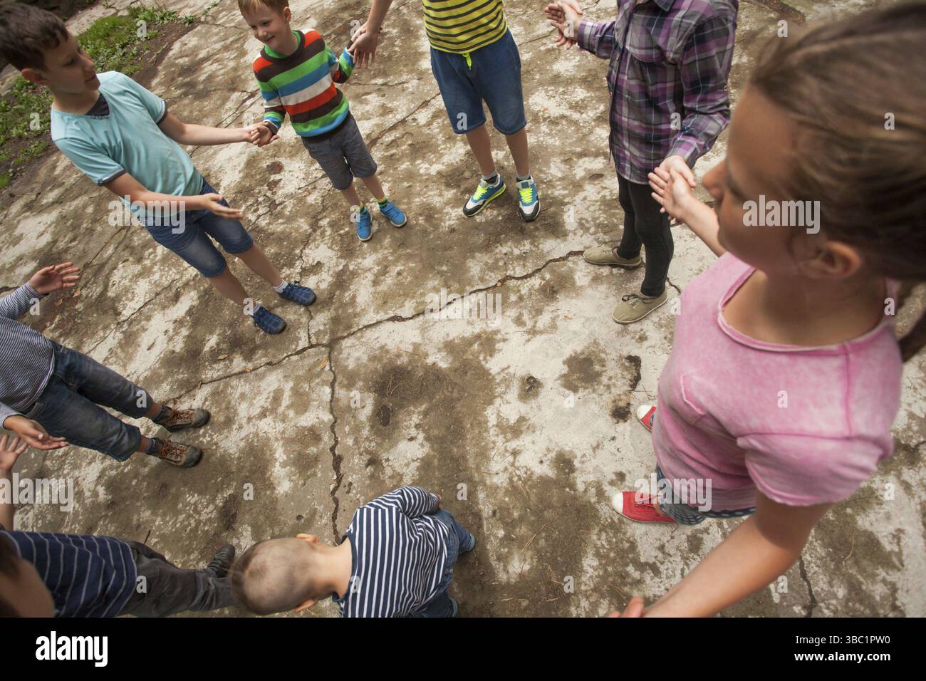 Children playing the game outdoors clapping hands in a circle Stock ...