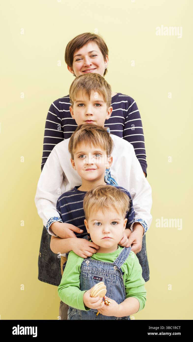 Mother with her three sons in the room. Family portrait Stock Photo - Alamy