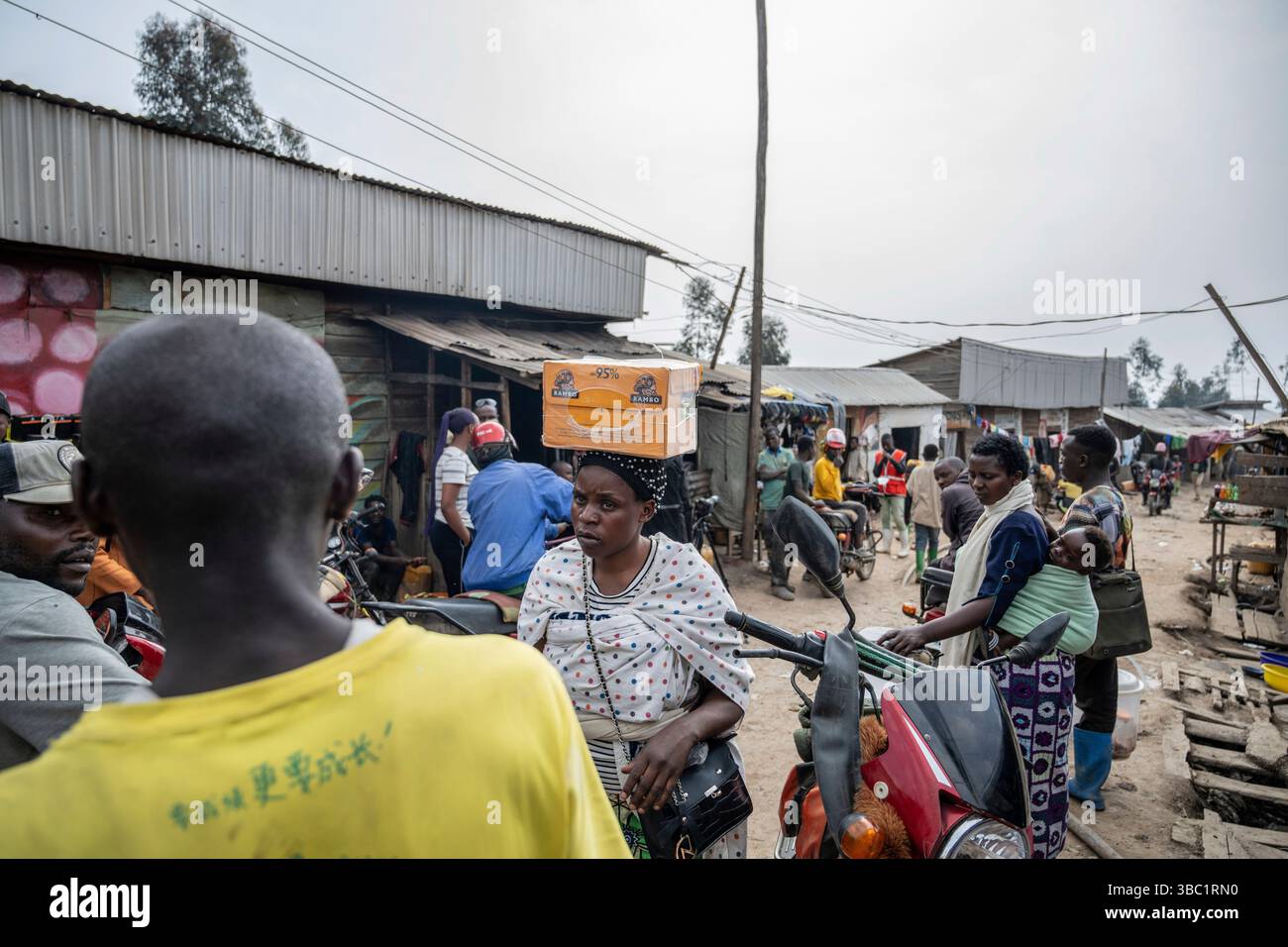 People walk through the town near the coltan mining quarry in Rubaya ...