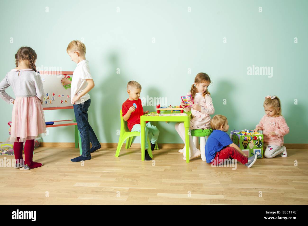 Different age kids at homeschooling. Educational and development toys ...